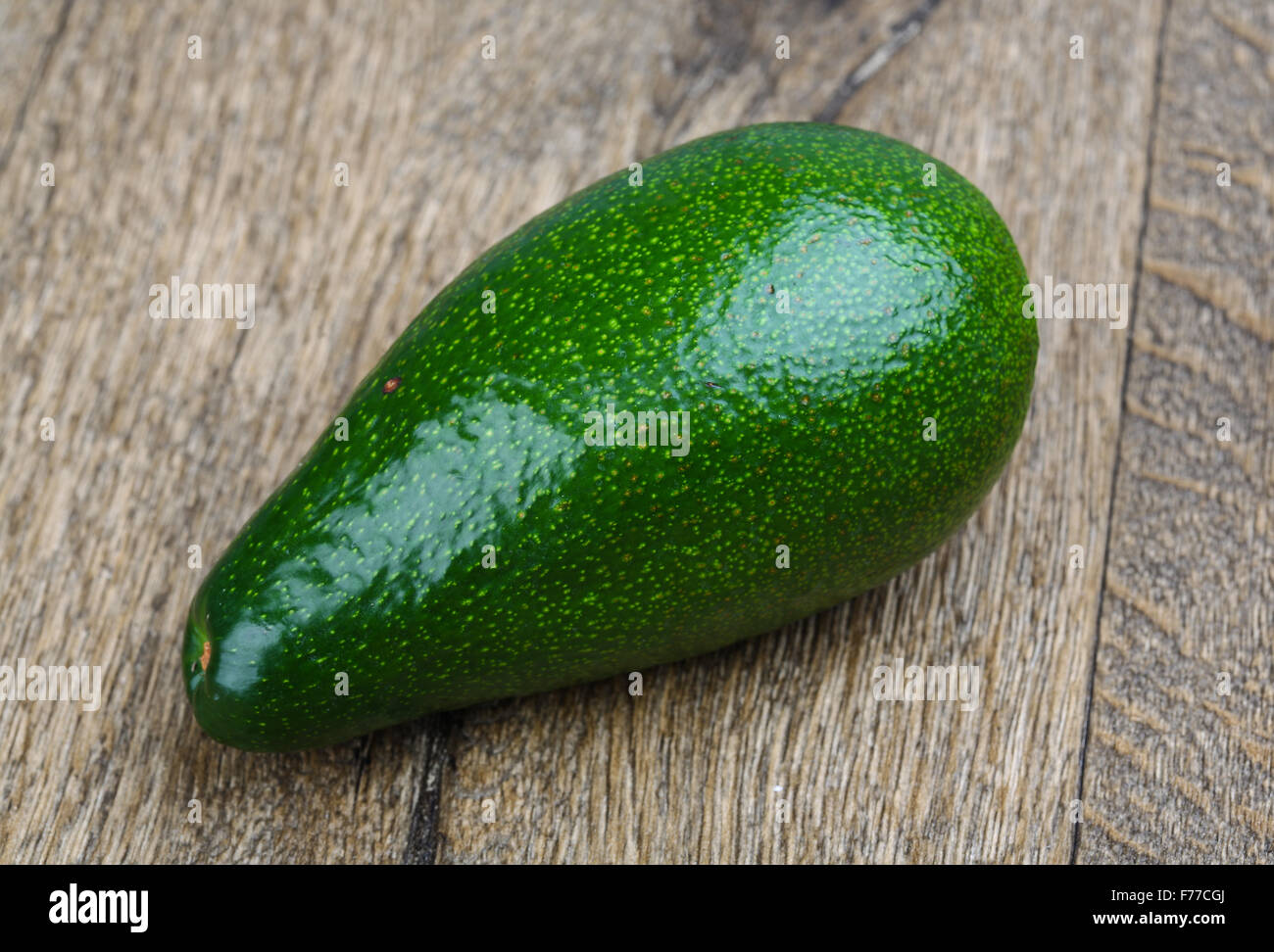 Fresh green ripe avocado on the wood background Stock Photo - Alamy