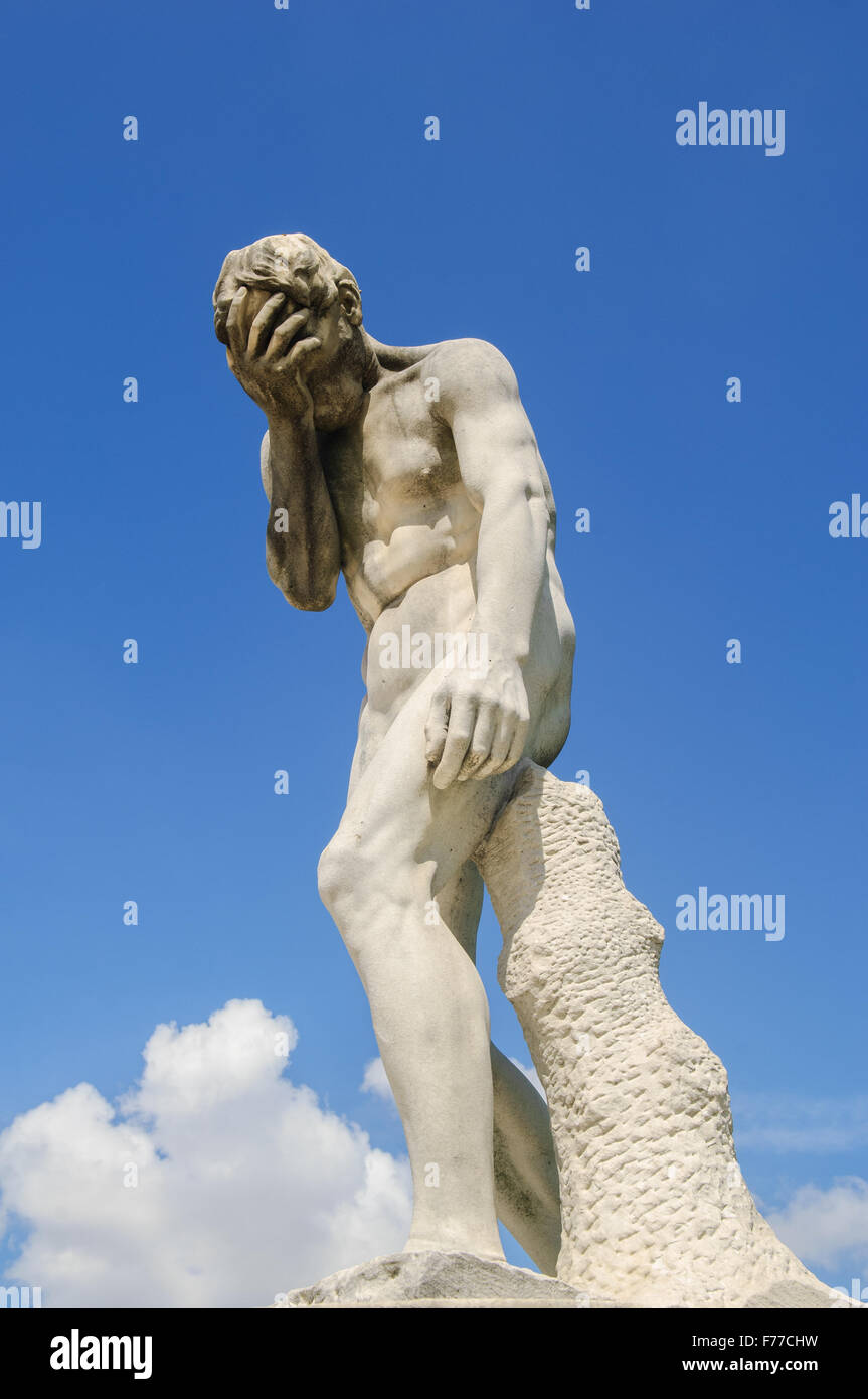 Statue of man covering his face with his had, located in Tuileries ...