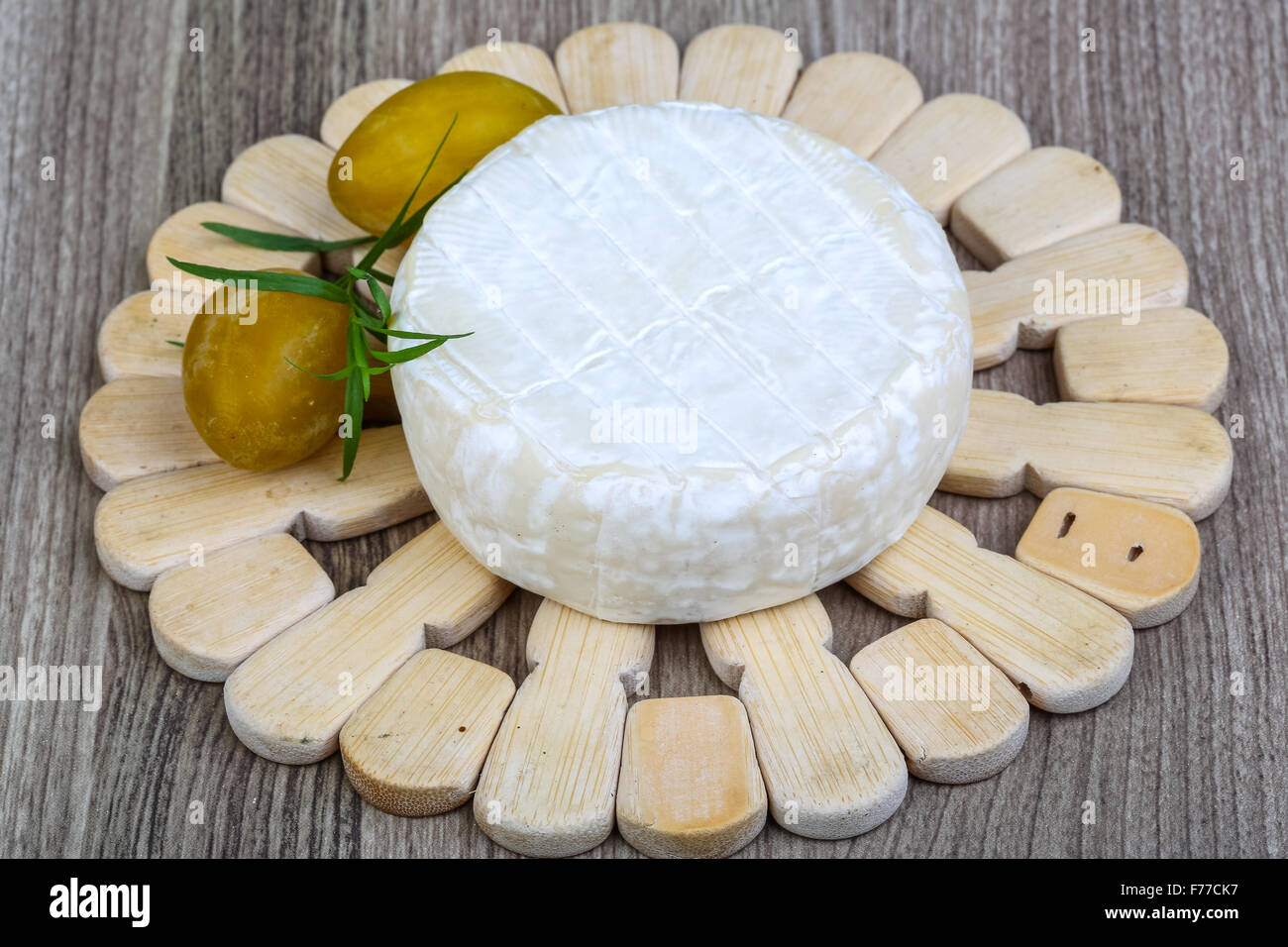 Round Brie cheese with yellow plums and estragon Stock Photo - Alamy