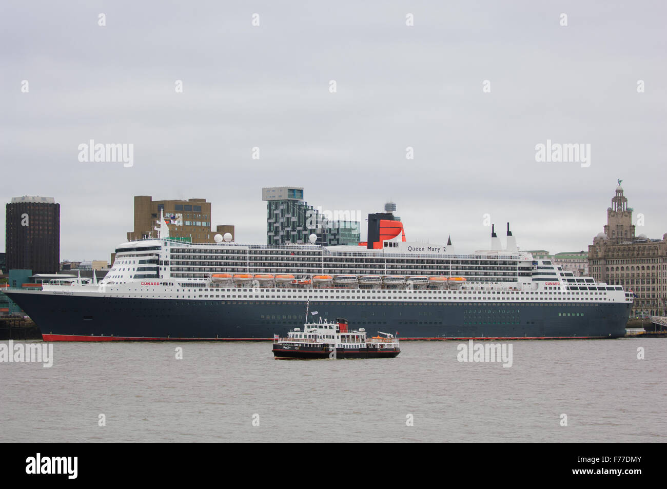 The Queen Mary 2, accompanied by a Mersey Ferry, during the 3 Queens ...