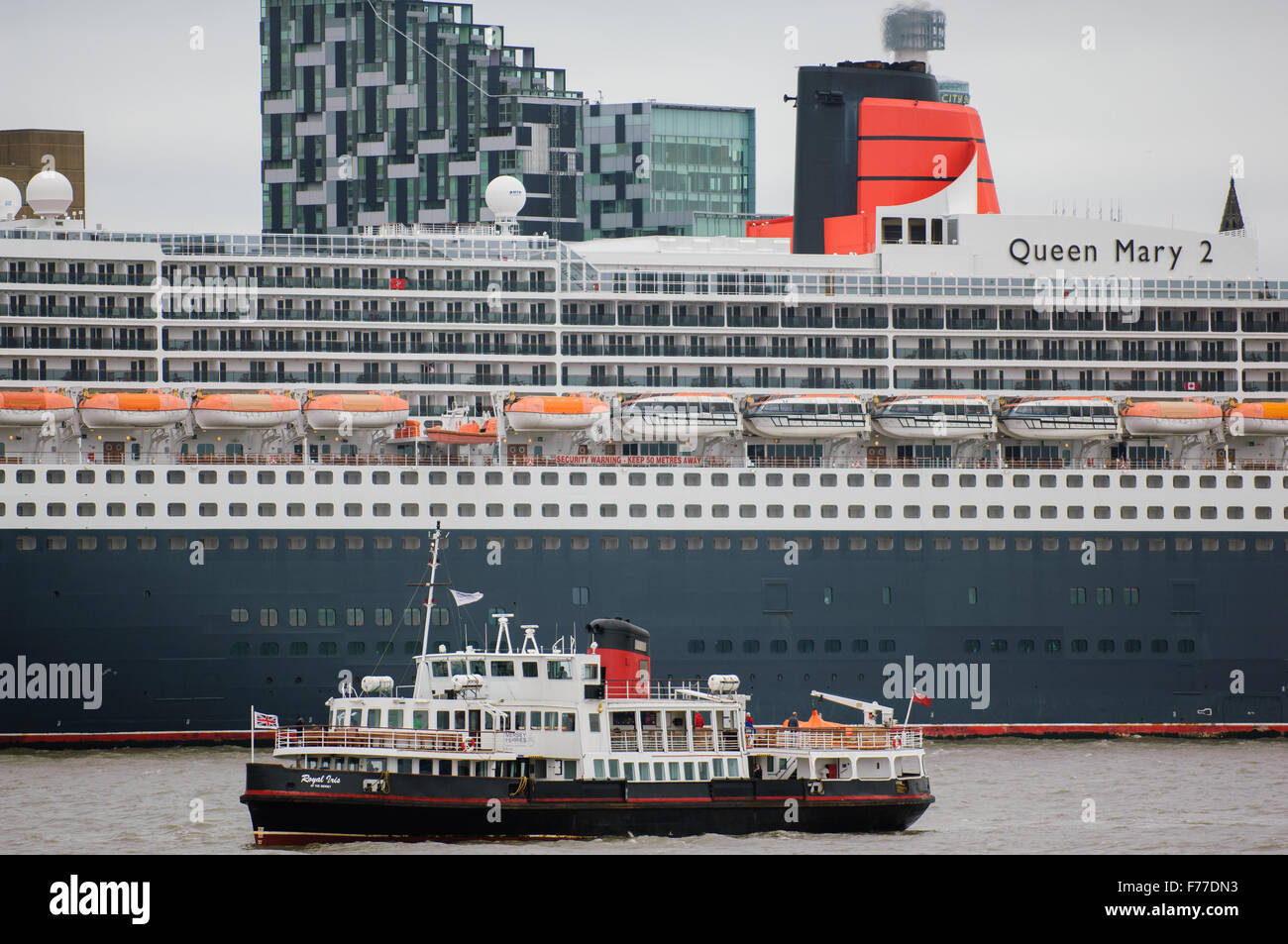 Closeup of the Queen Mary 2, accompanied by a Mersey Ferry, during the ...