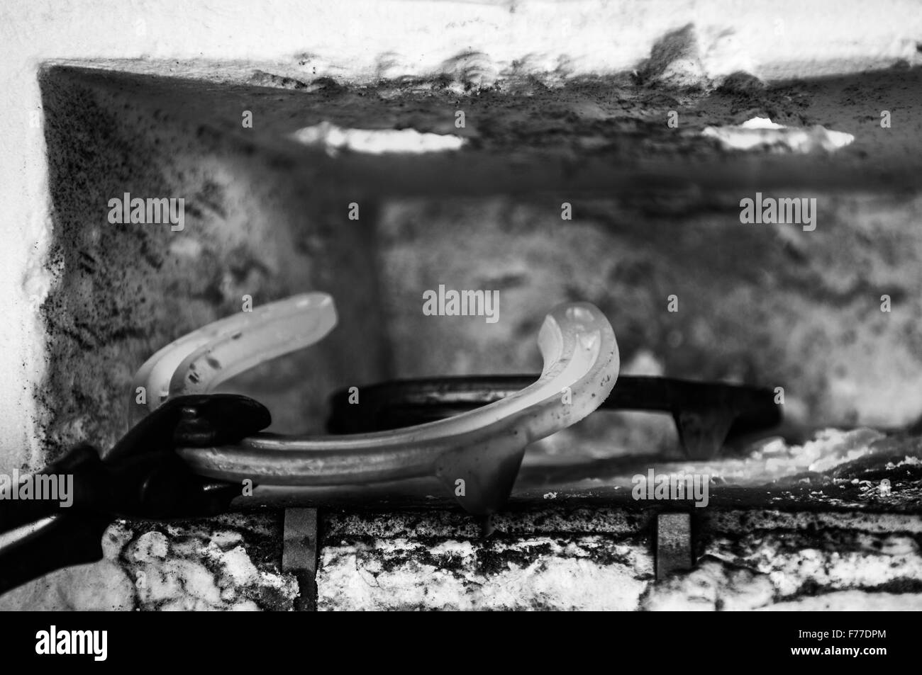 Black & white photo of red hot horseshoes inside a farriers forge Stock ...