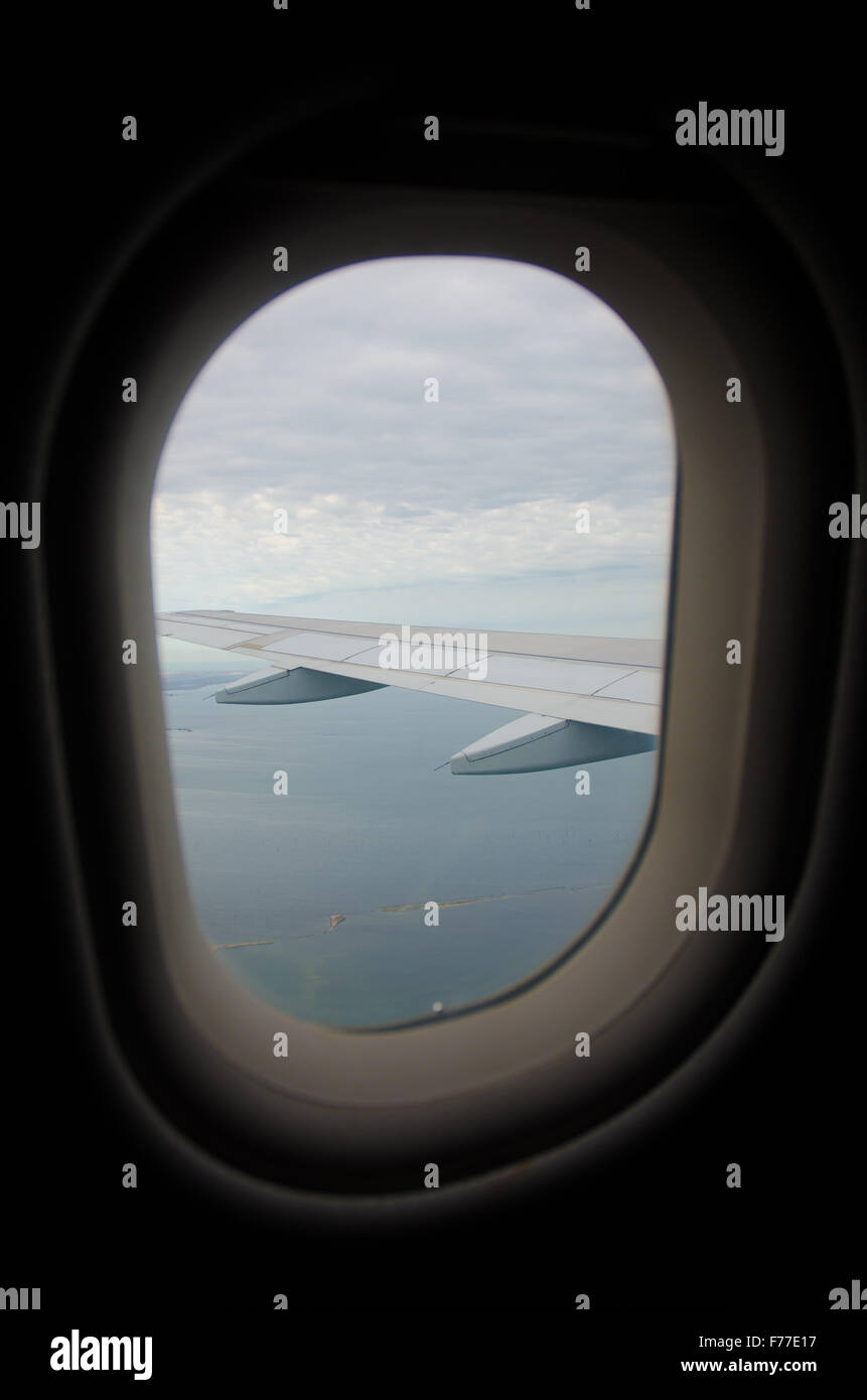 Airplane wing out of window Stock Photo - Alamy
