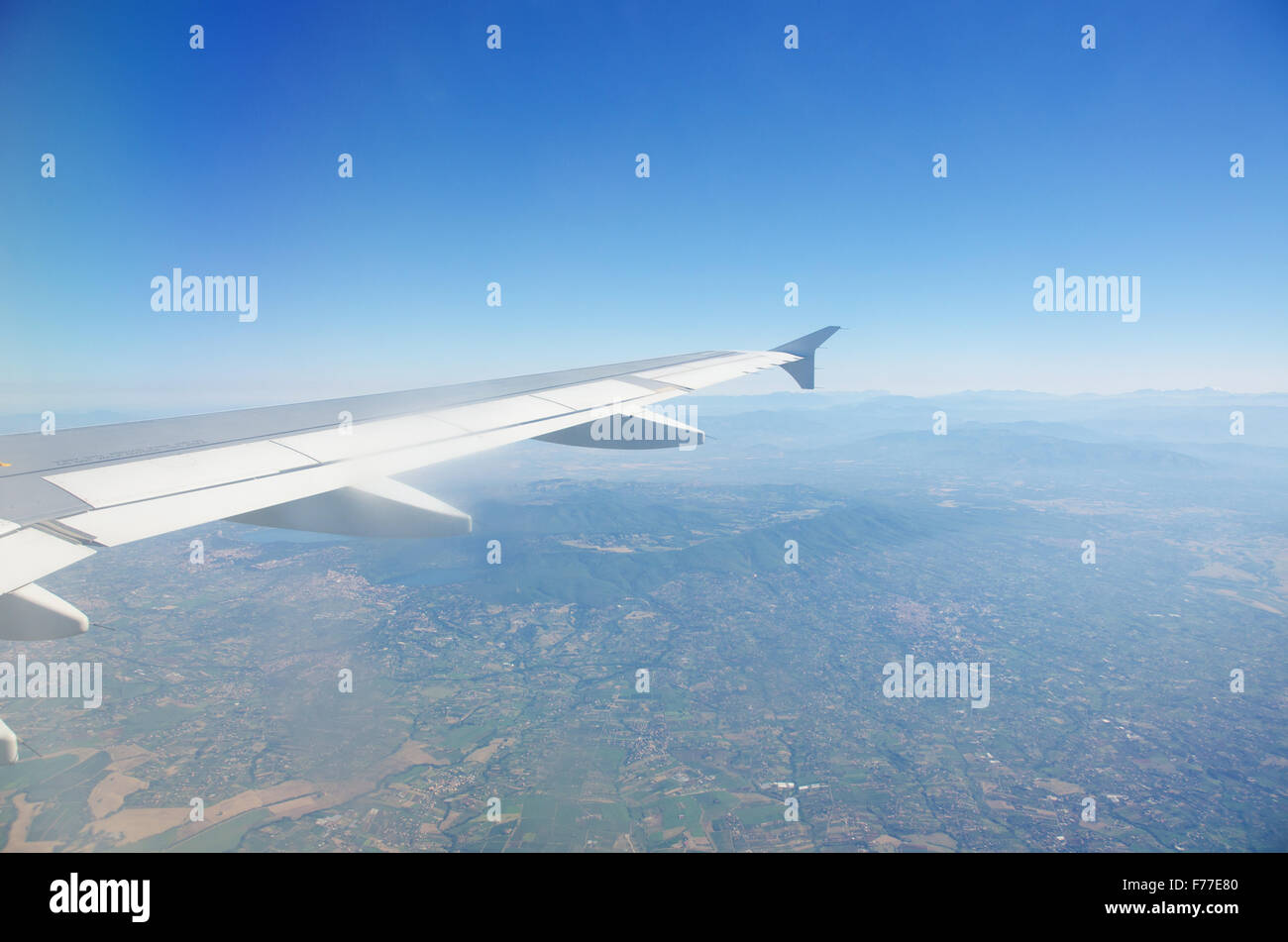 Airplane wing out of window Stock Photo - Alamy