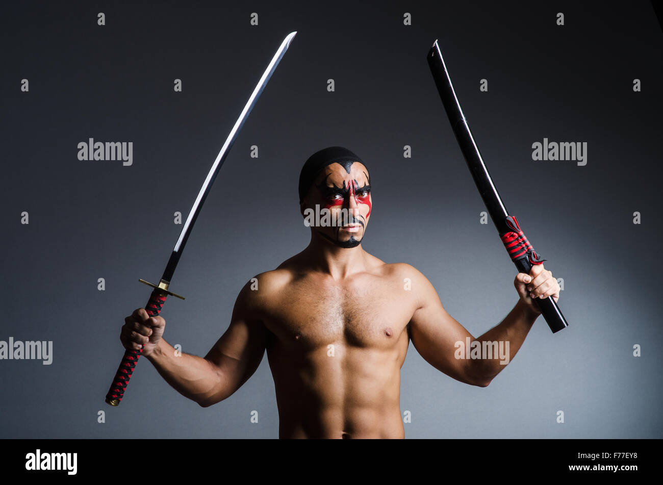 Man with sword and face paint Stock Photo - Alamy