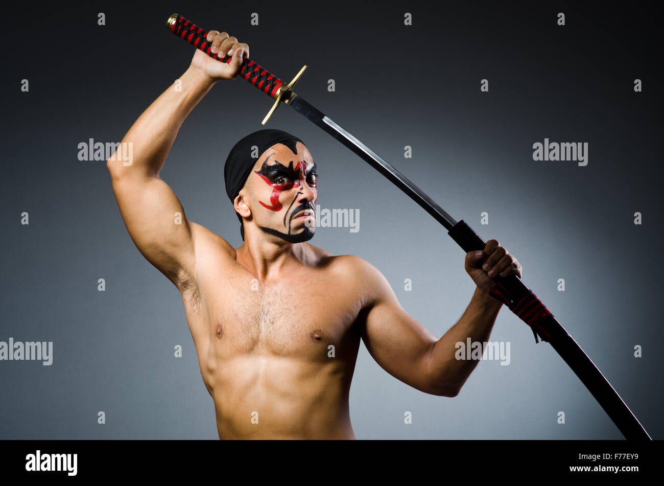 Man with sword and face paint Stock Photo - Alamy