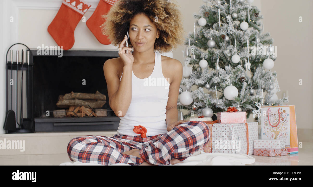 Attractive woman phoning her friends at Christmas Stock Photo - Alamy