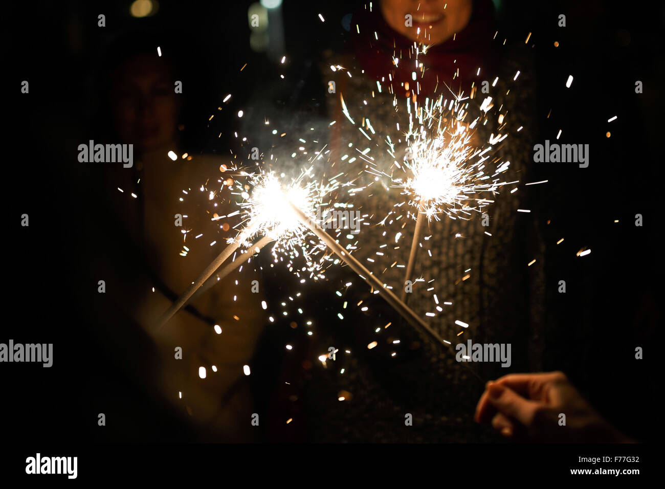 salute. fireworks. sparklers. Happy and fun people light sparklers ...