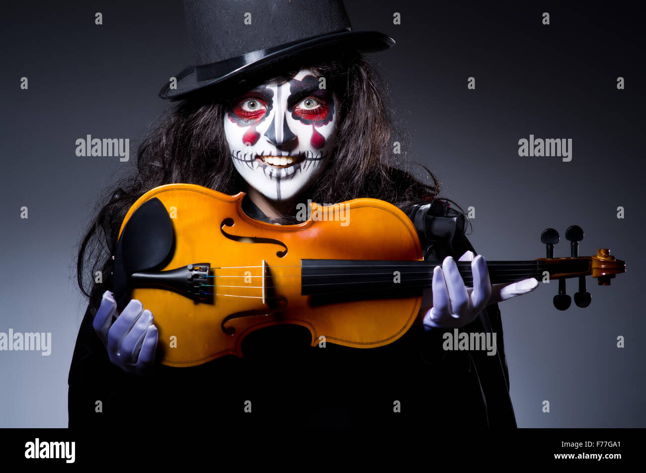 Monster playing violin in dark room Stock Photo - Alamy