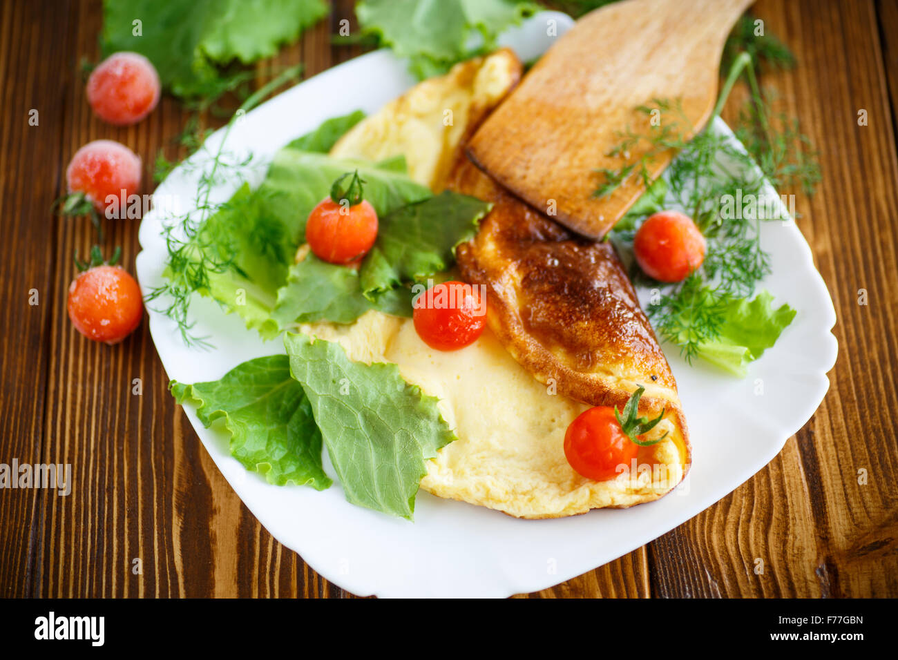 Omelette with tomatoes and lettuce Stock Photo - Alamy