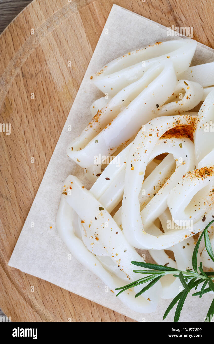 Raw squid rings with herbs - ready for cooking Stock Photo - Alamy