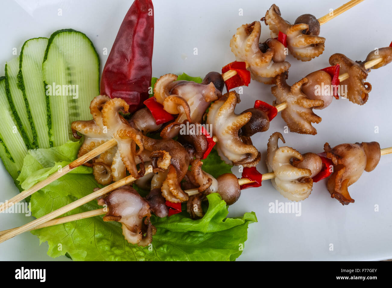 Grilled octopus skewers with red pepper and onion Stock Photo - Alamy