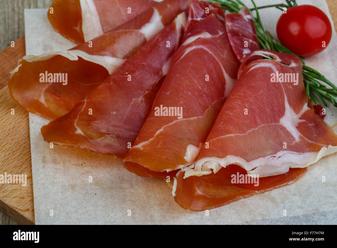 Spanish traditional snack - Jamon with tomato and rosemary Stock Photo ...