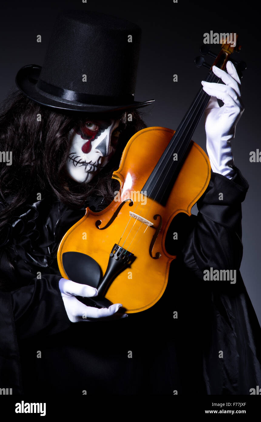 Monster playing violin in dark room Stock Photo - Alamy