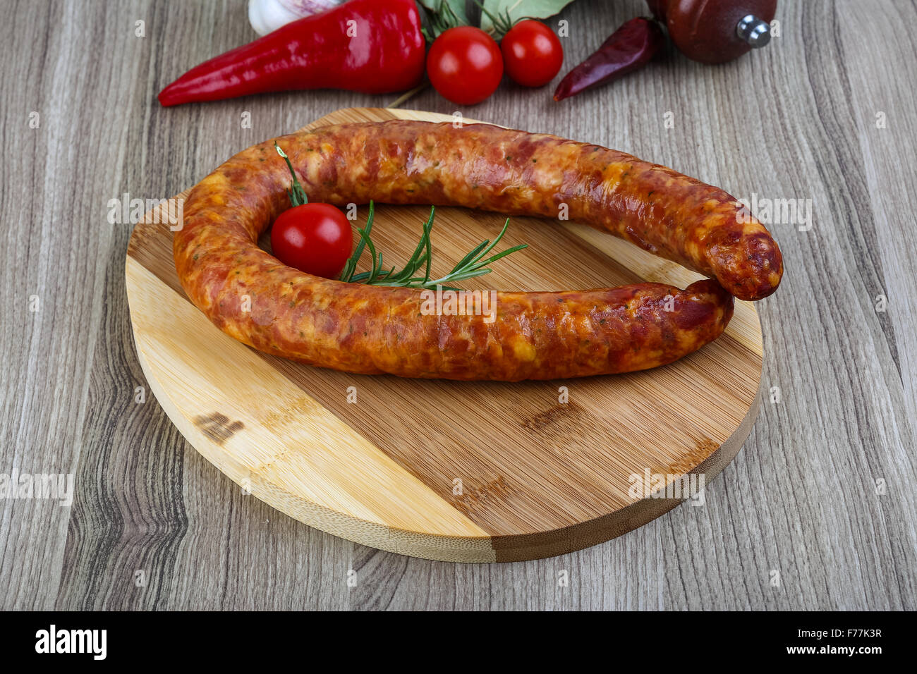 Sausage ring with rosemary and pepper on the wood background Stock ...