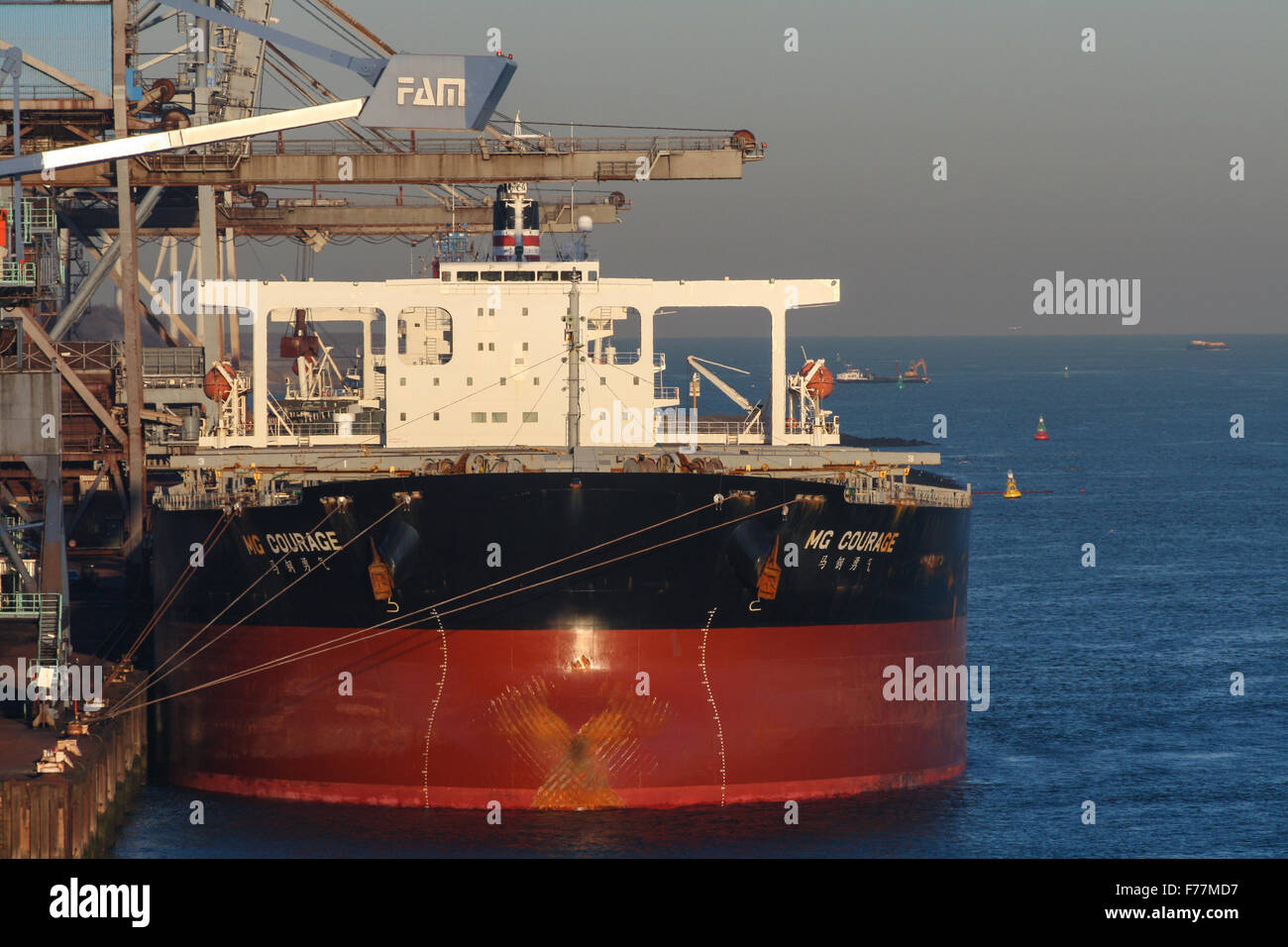 North Sea, MG Courage bulk carrier in Rotterdam harbour at sunrise with ...