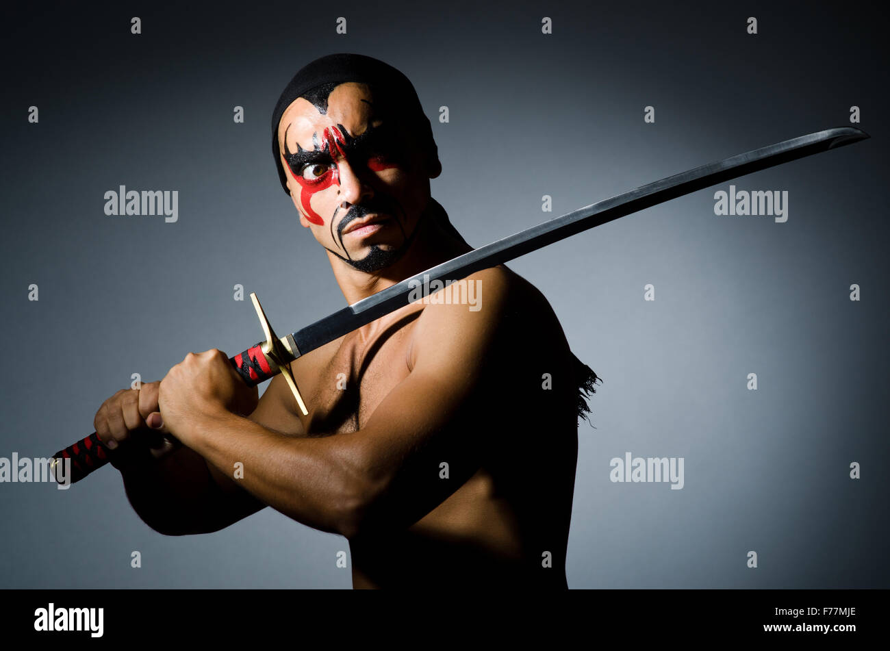 Man with sword and face paint Stock Photo - Alamy