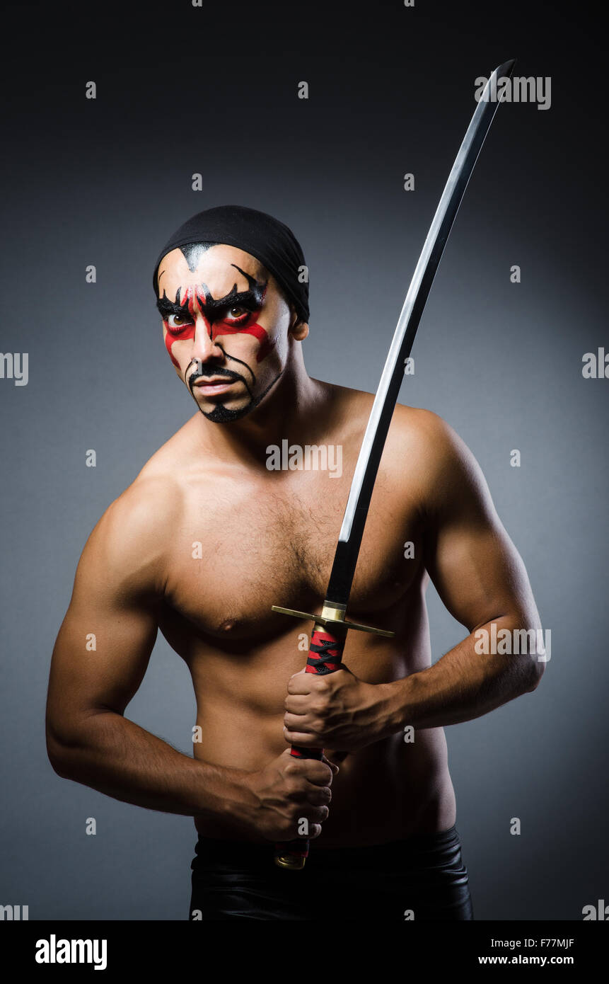 Man with sword and face paint Stock Photo - Alamy