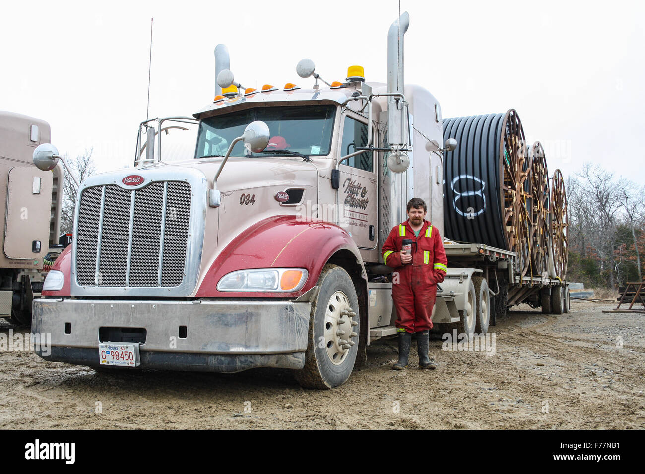 Two American Peterbilt 379 semi trucks hauling reels of HDPE plastic ...