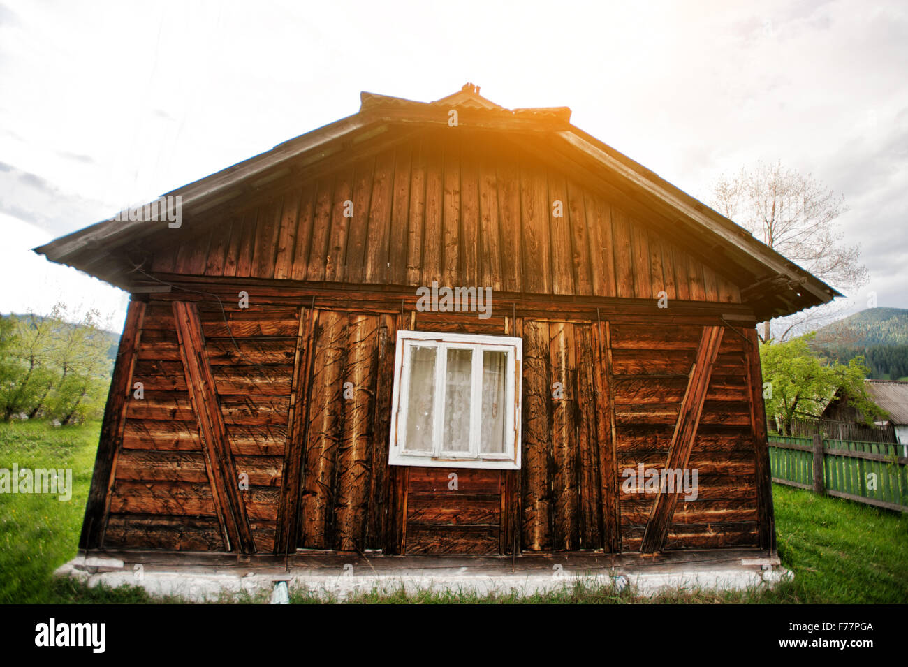Antique wooden house with one window on sunset Stock Photo - Alamy