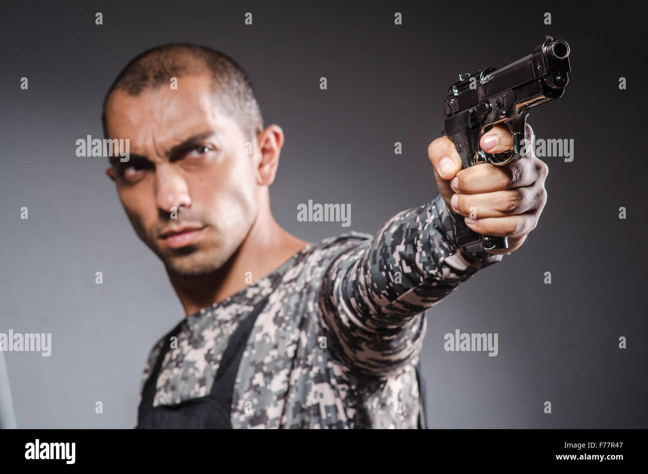 Soldier with guns against dark background Stock Photo - Alamy