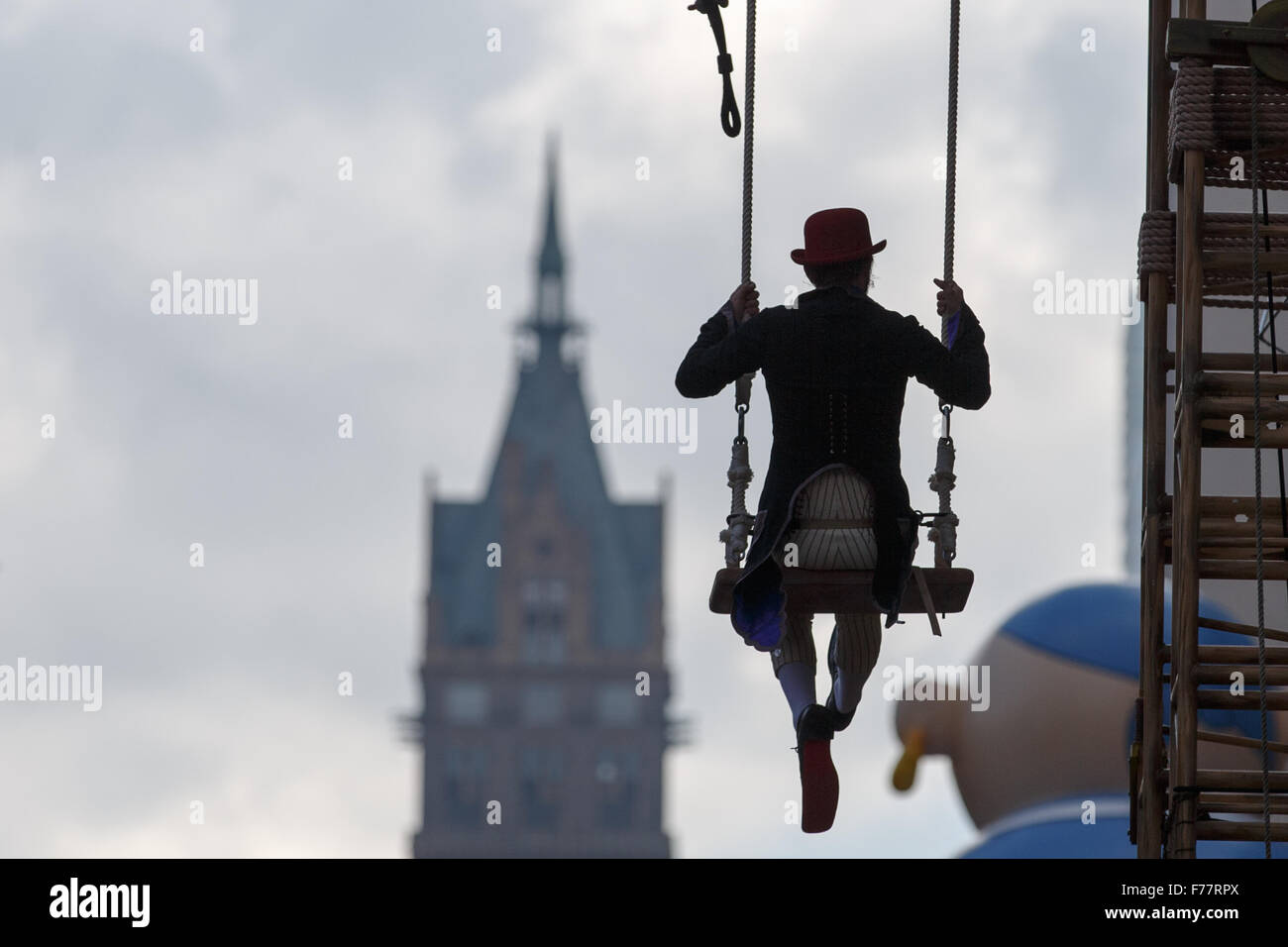 New York, USA. 26th Nov, 2015. An acrobat swings on the "Dreamseeker ...