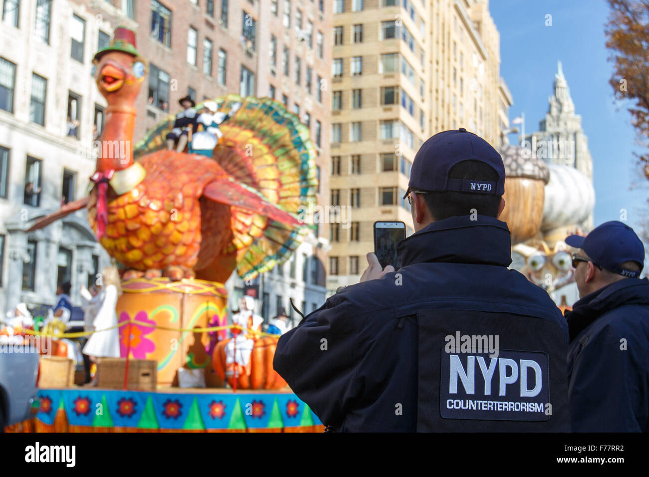 New York, USA. 26th Nov, 2015. A NYPD police officer takes photo of a ...