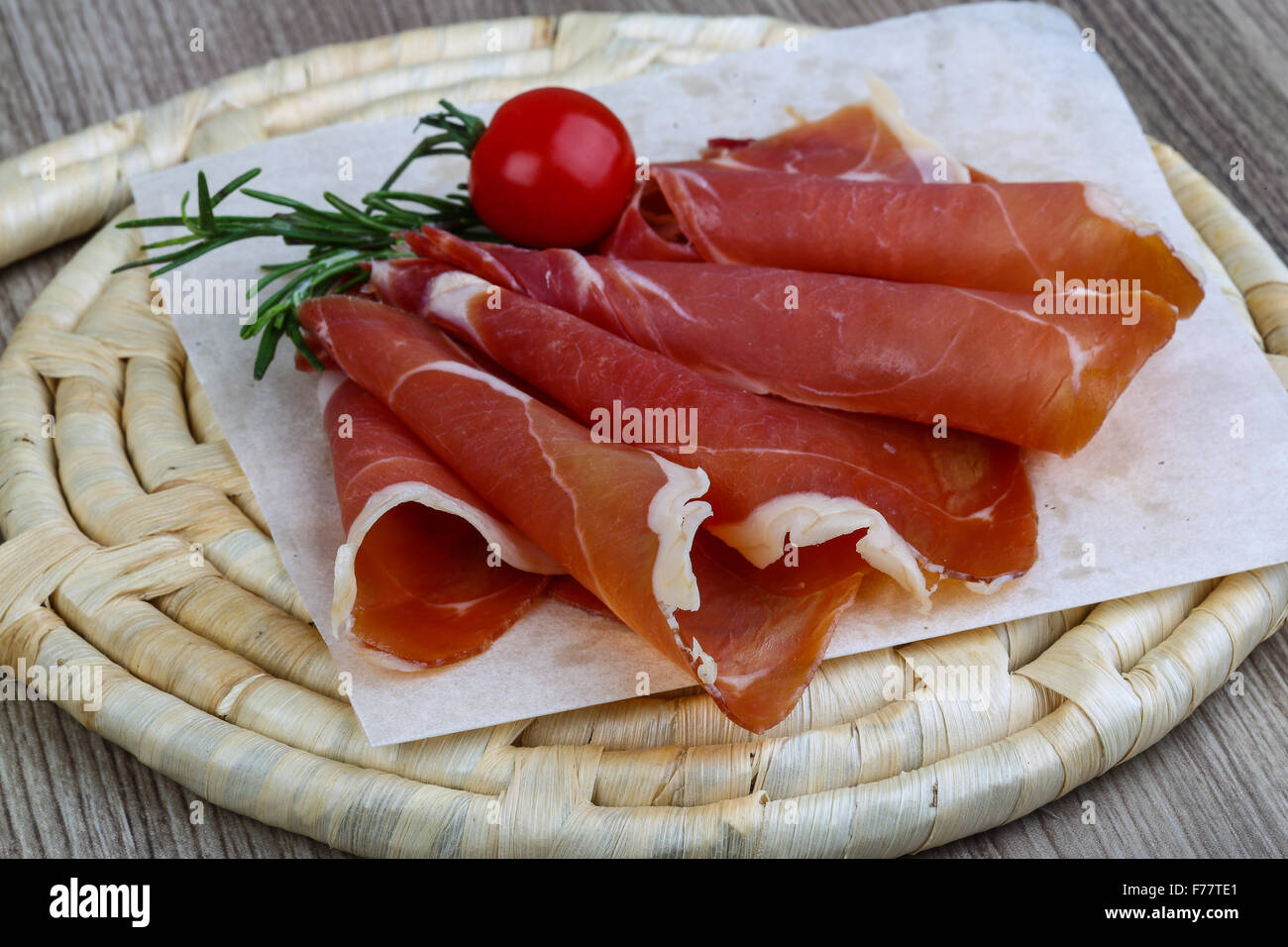 Spanish traditional snack - Jamon with tomato and rosemary Stock Photo ...