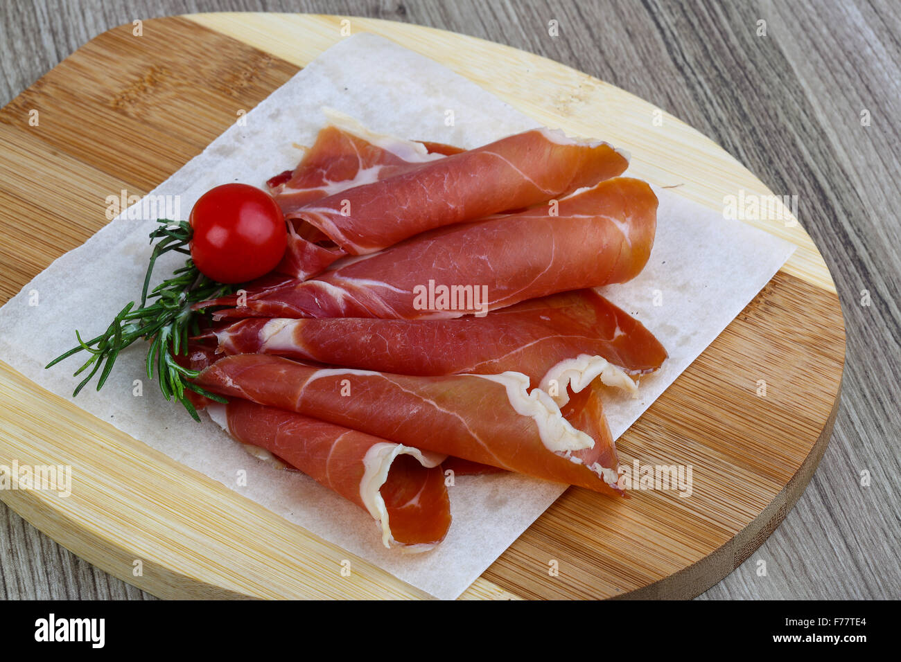 Spanish traditional snack - Jamon with tomato and rosemary Stock Photo ...