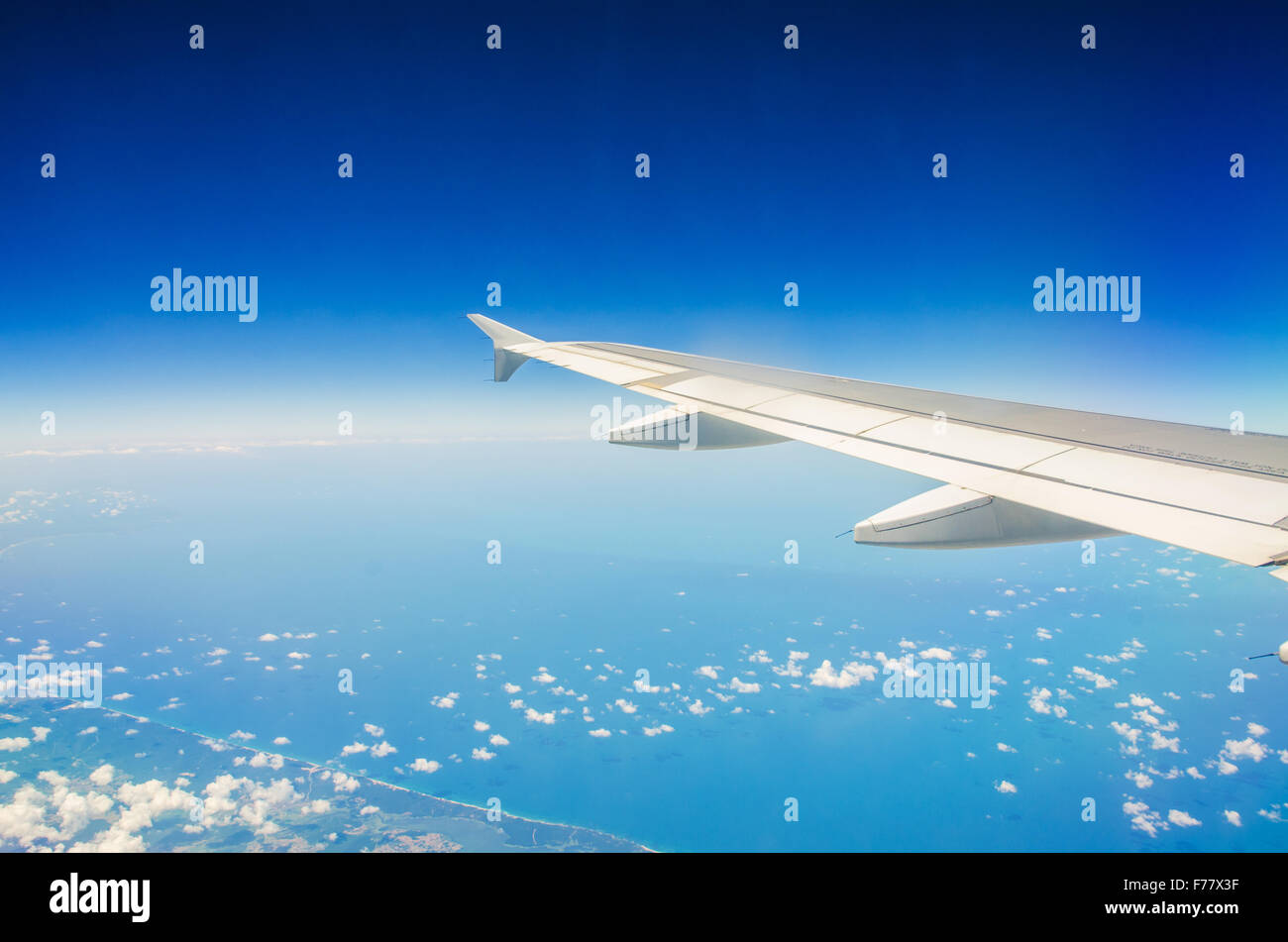 Airplane wing out of window Stock Photo - Alamy
