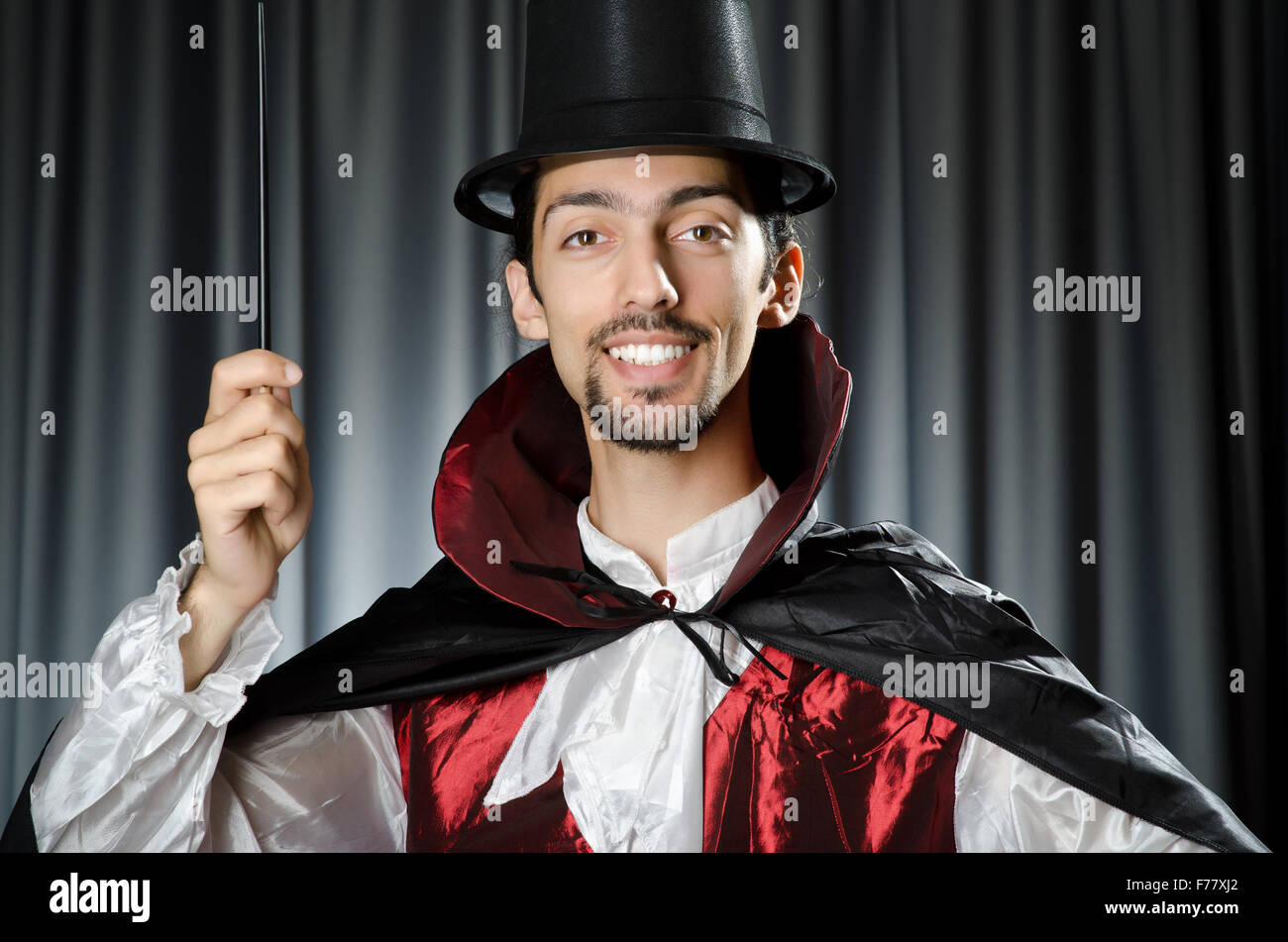 Magician doing tricks on white Stock Photo - Alamy