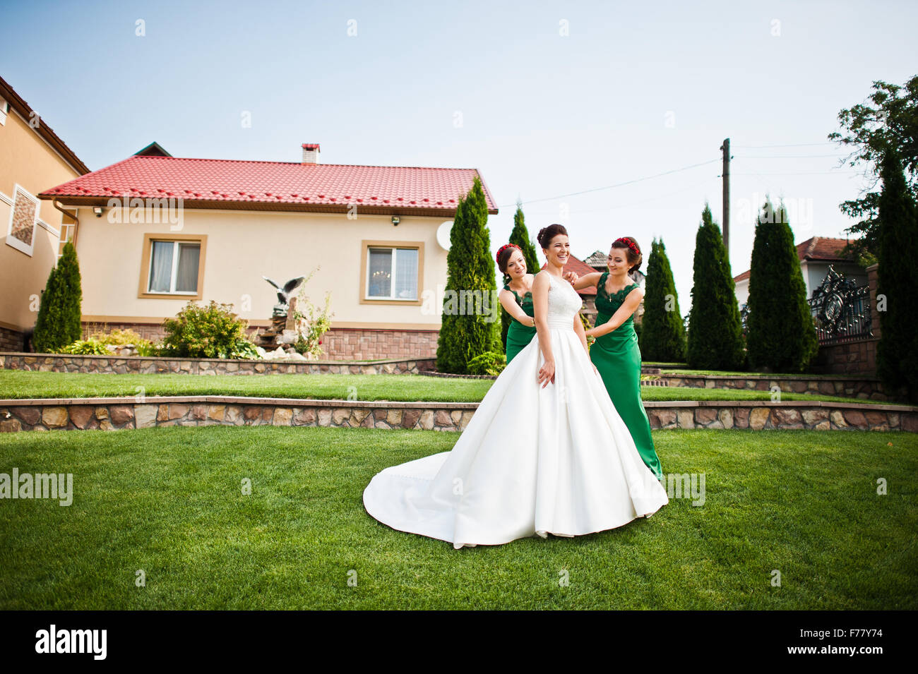 Bride in the courtyard of the mansion house with bridesmaids Stock ...