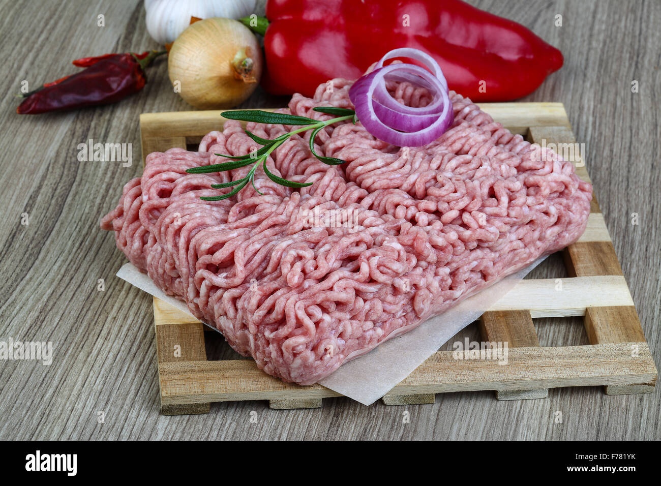 Raw minced pork meat with onion and rosemary ready for cooking Stock ...