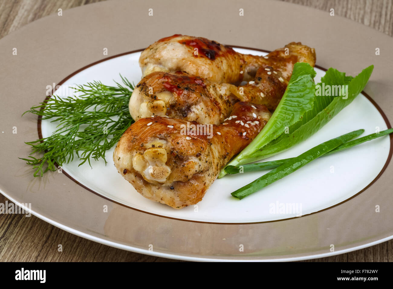 Grilled chicken legs with sesame seeds, dill and green onion Stock ...