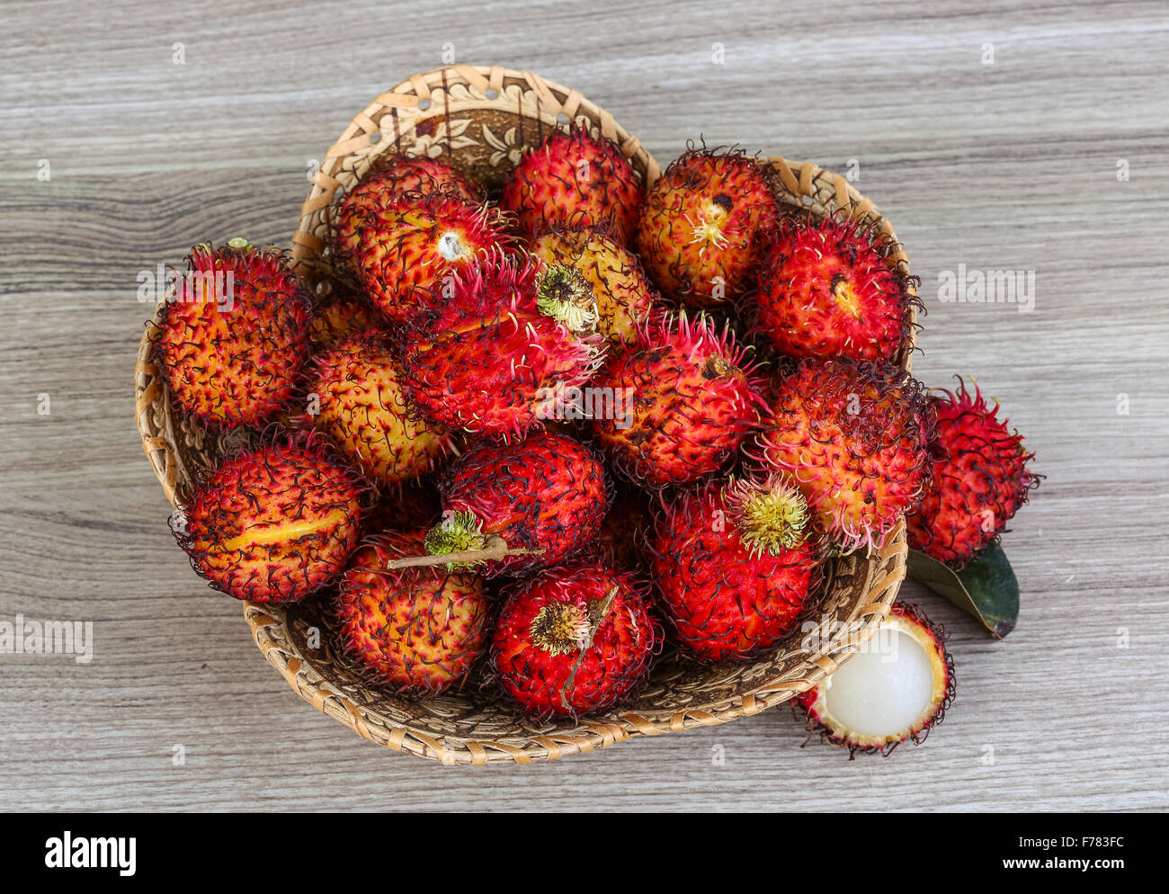 Asian fruit - rambutan - on the wood background Stock Photo - Alamy