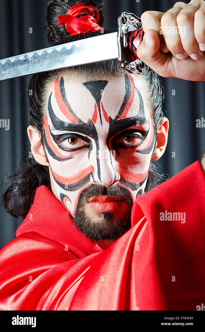 Man with face mask and sword Stock Photo - Alamy