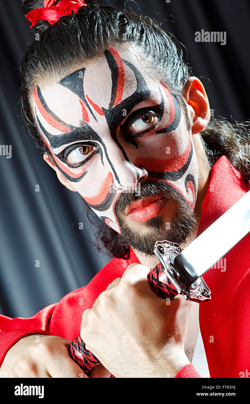 Man with face mask and sword Stock Photo - Alamy