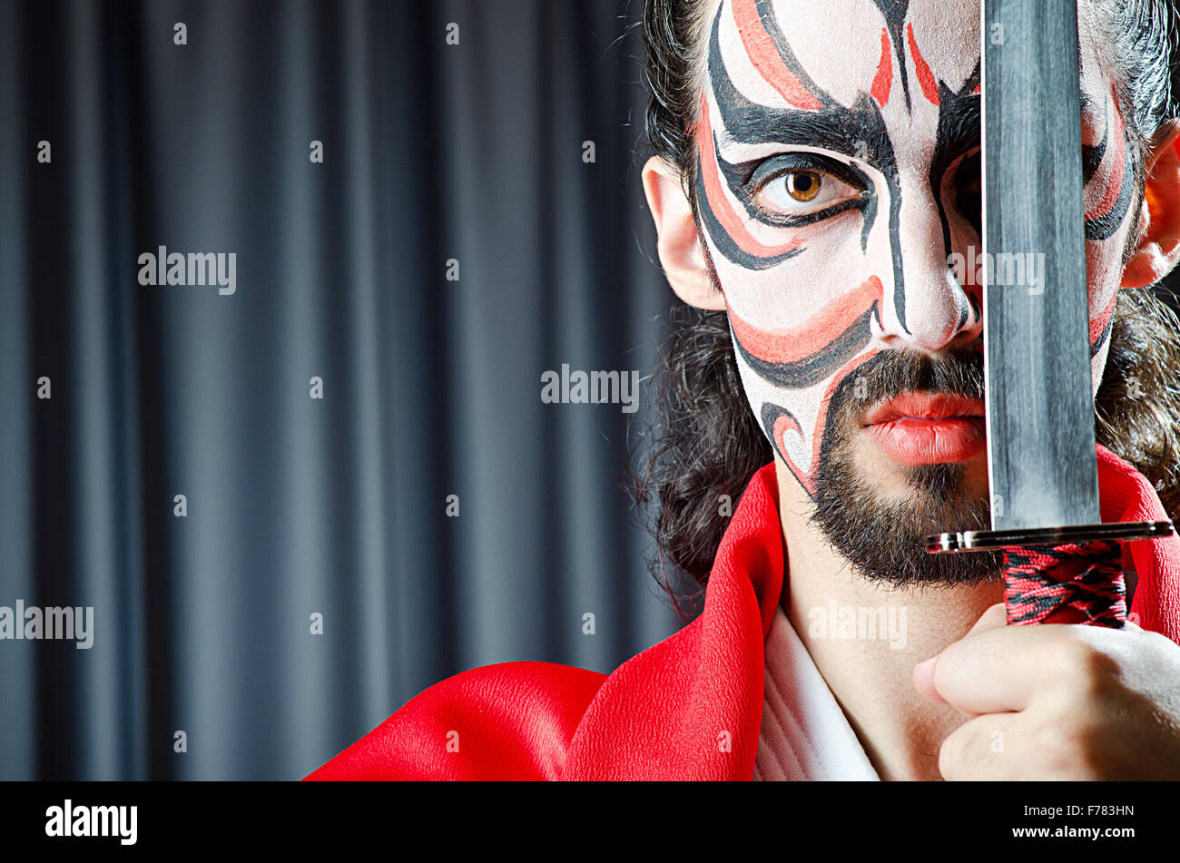 Man with face mask and sword Stock Photo - Alamy