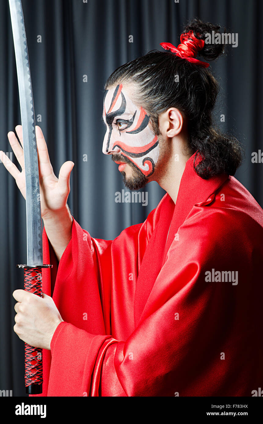 Man with face mask and sword Stock Photo - Alamy