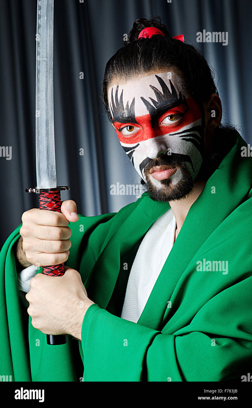 Man with face mask and sword Stock Photo - Alamy