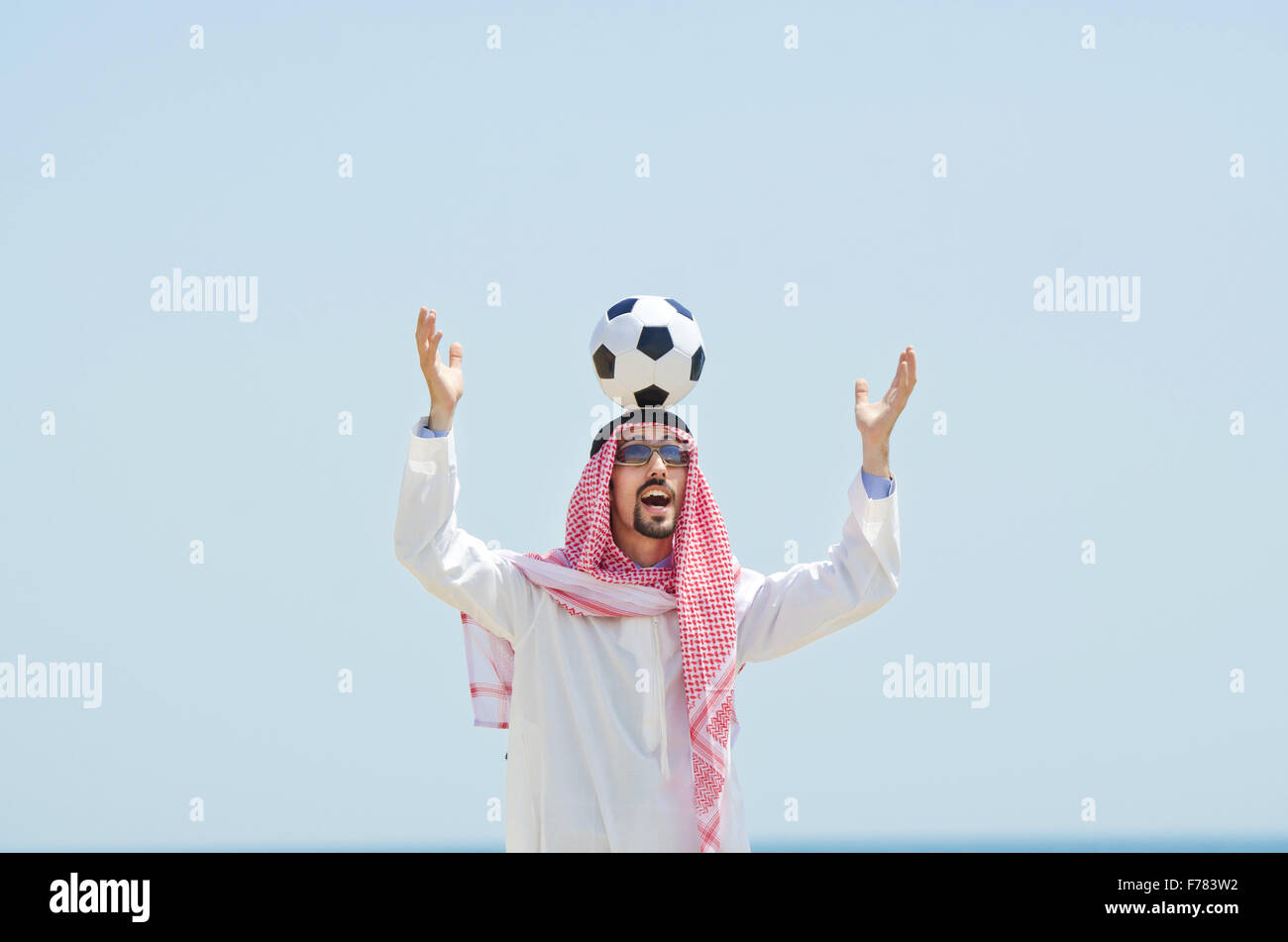 Arab with footbal at seaside Stock Photo - Alamy