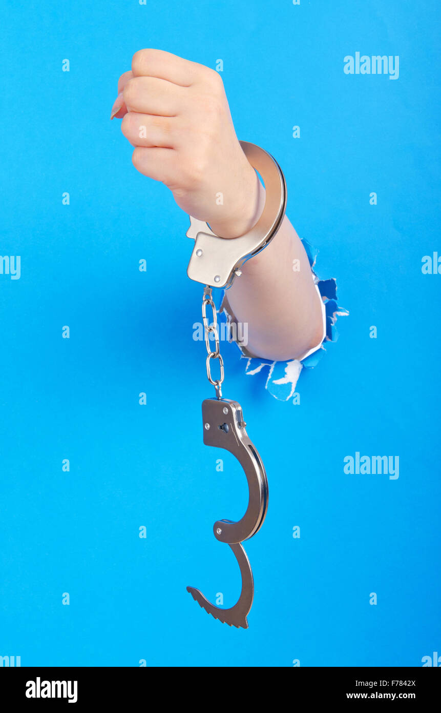 Hand with handcuffs out of paper Stock Photo - Alamy