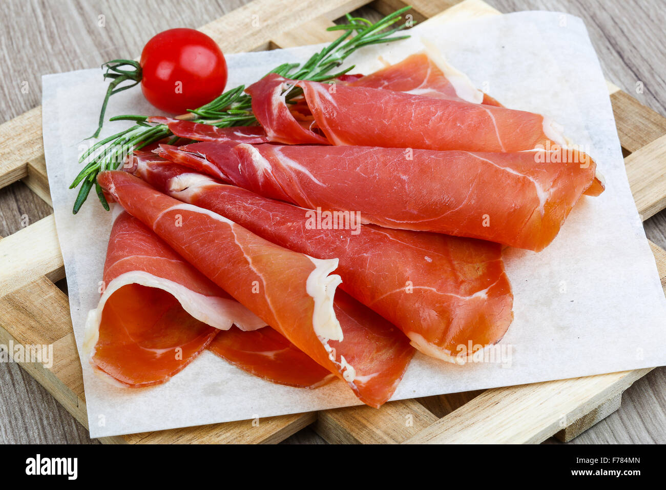 Spanish traditional snack - Jamon with tomato and rosemary Stock Photo ...