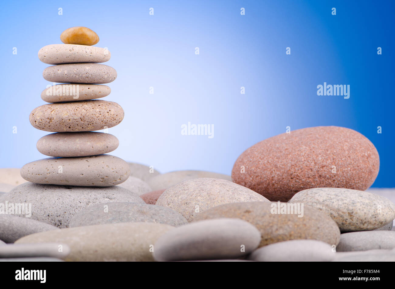 Pebbles stack against gradient background Stock Photo - Alamy
