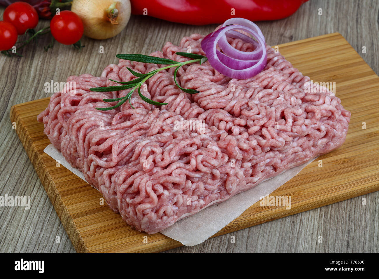 Raw minced pork meat with onion and rosemary ready for cooking Stock ...