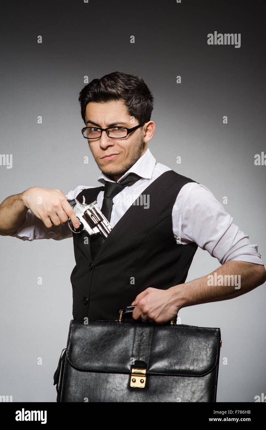 Man with gun and briefcase Stock Photo - Alamy