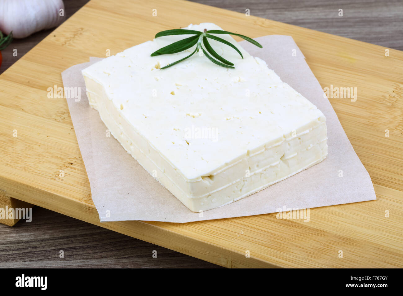 White bulgarian cheese brinza with rosemary on the wood background ...