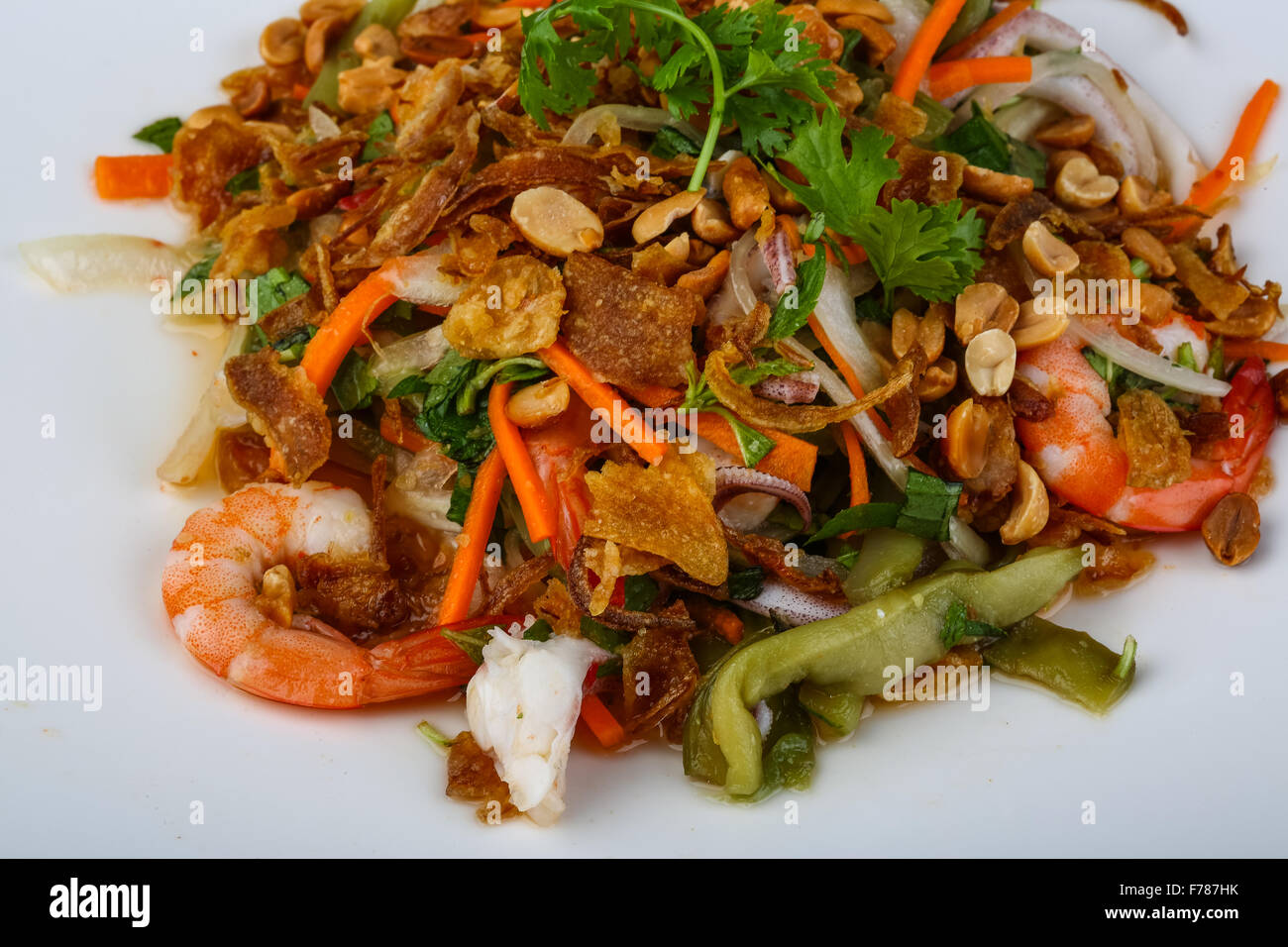 Traditional Asian seafood salad with nuts on wood background Stock ...