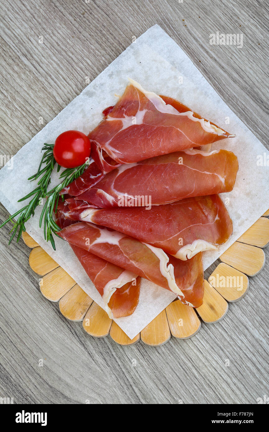 Spanish traditional snack - Jamon with tomato and rosemary Stock Photo ...