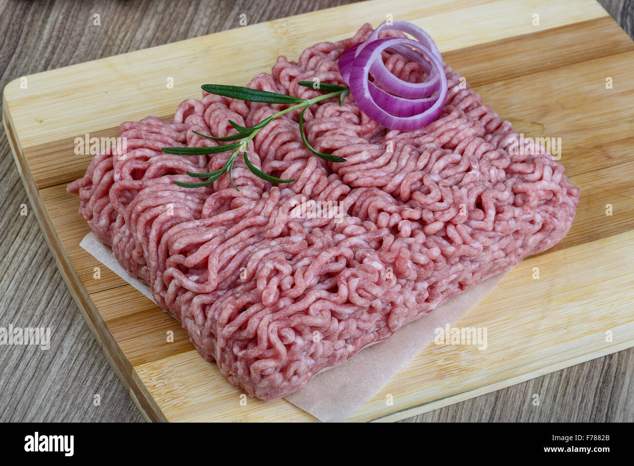 Raw minced pork meat with onion and rosemary ready for cooking Stock ...